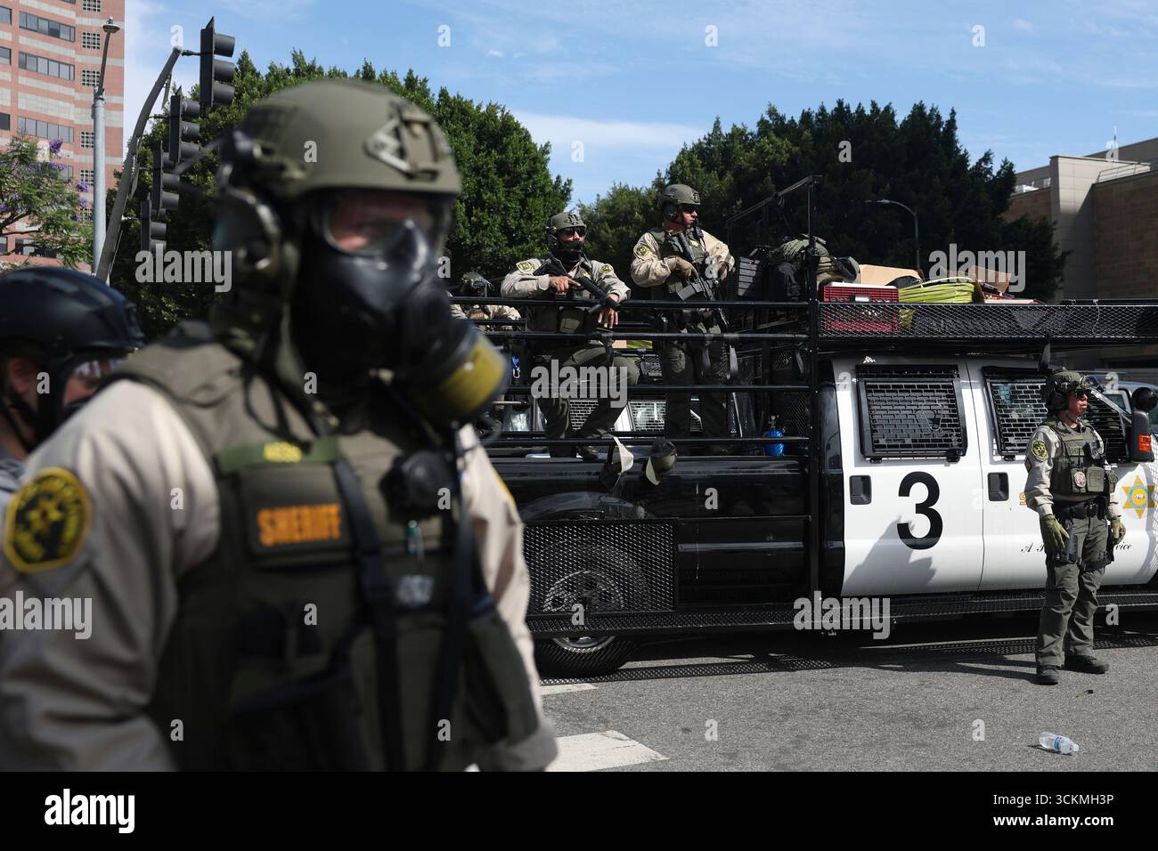 FILE - Law enforcement officers stand guard during a protest June 14 ...