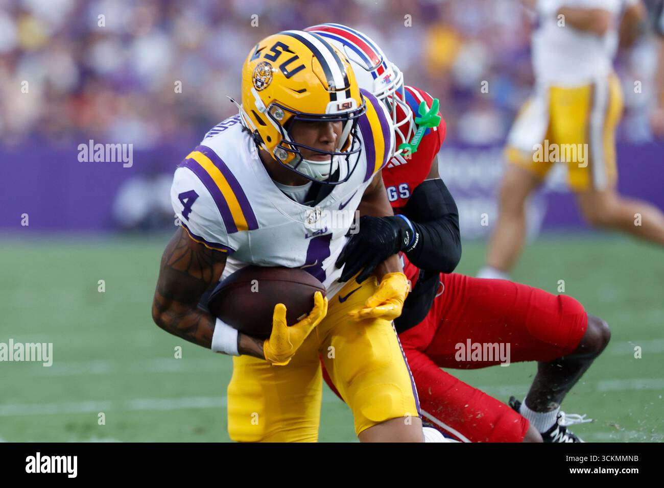 LSU wide receiver Nic Anderson (4) carries the ball as he gets tackled ...