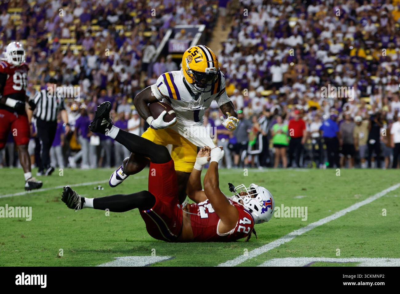 LSU wide receiver Aaron Anderson (1) carries the ball as Sifa Leota (42 ...