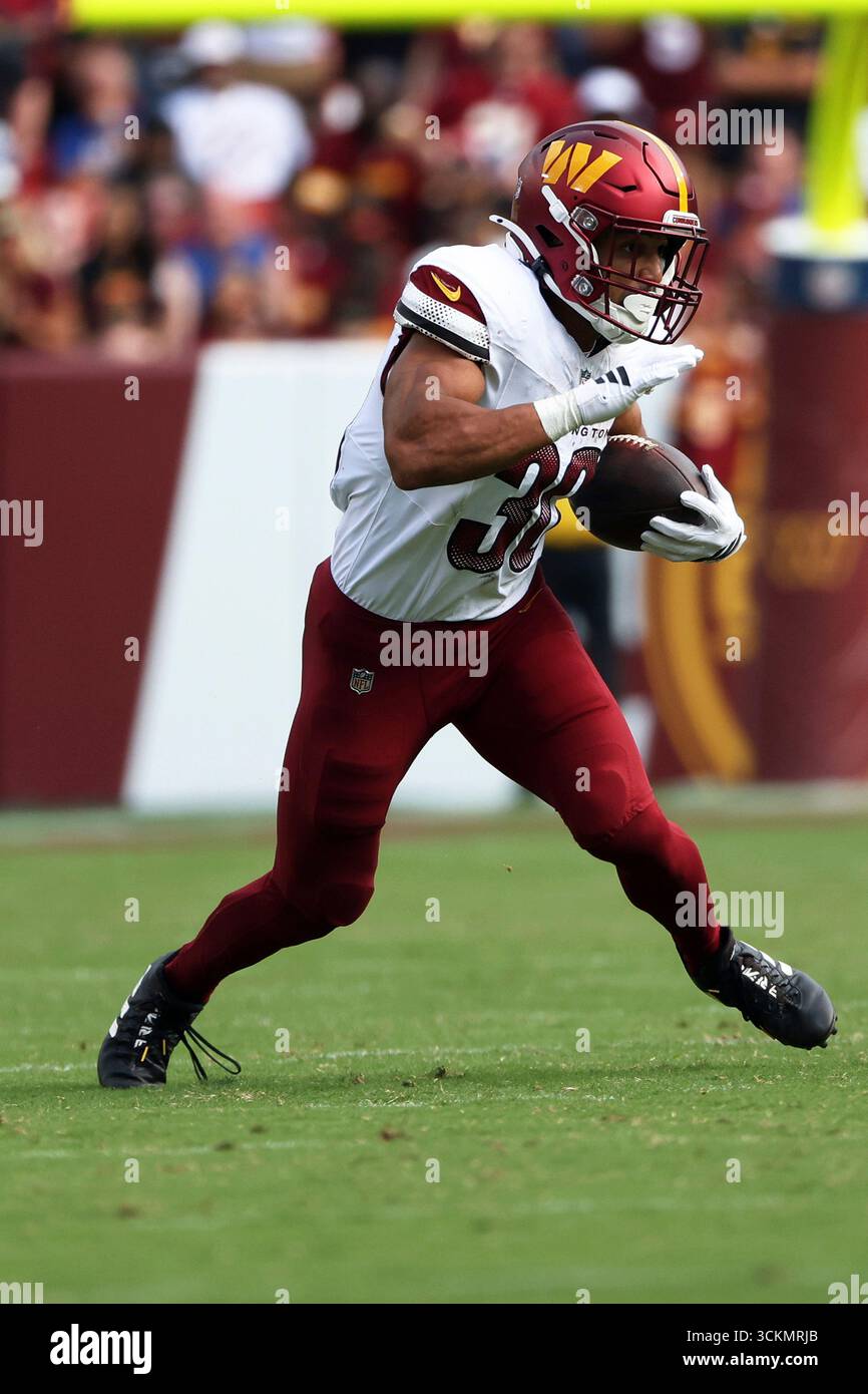 Washington Commanders running back Austin Ekeler (30)runs with the ball ...