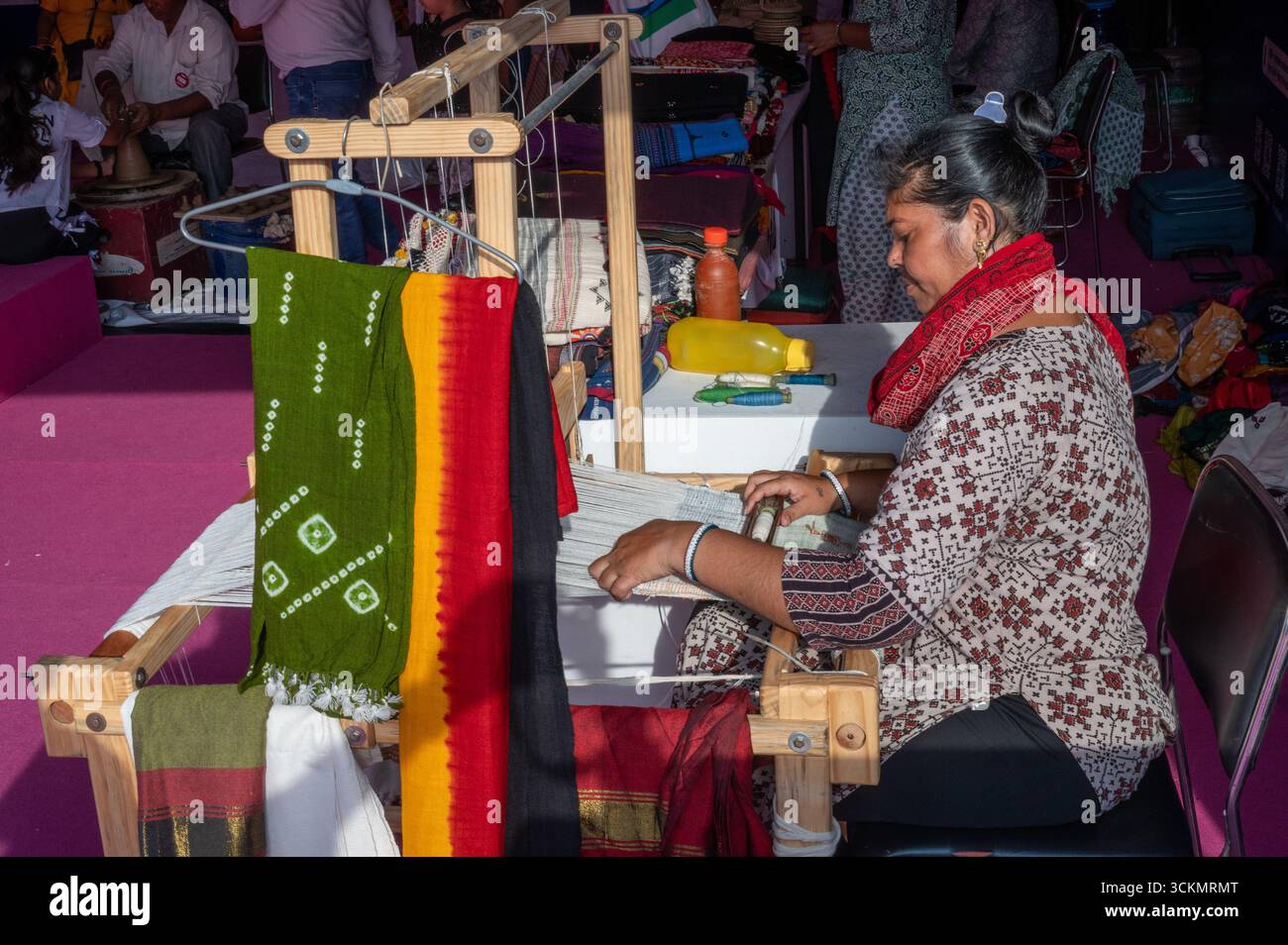 A female artisan weaves a Chomokh design on a stole, a traditional ...