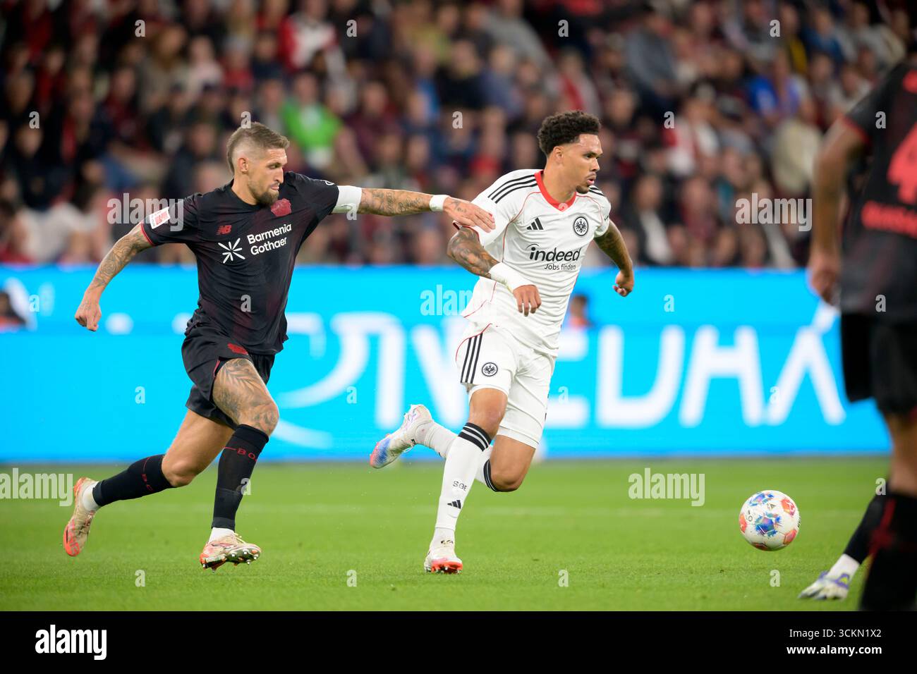 Left to right: Robert Andrich (Bayer Leverkusen), Nnamdi Collins (Eintracht Frankfurt), action ...