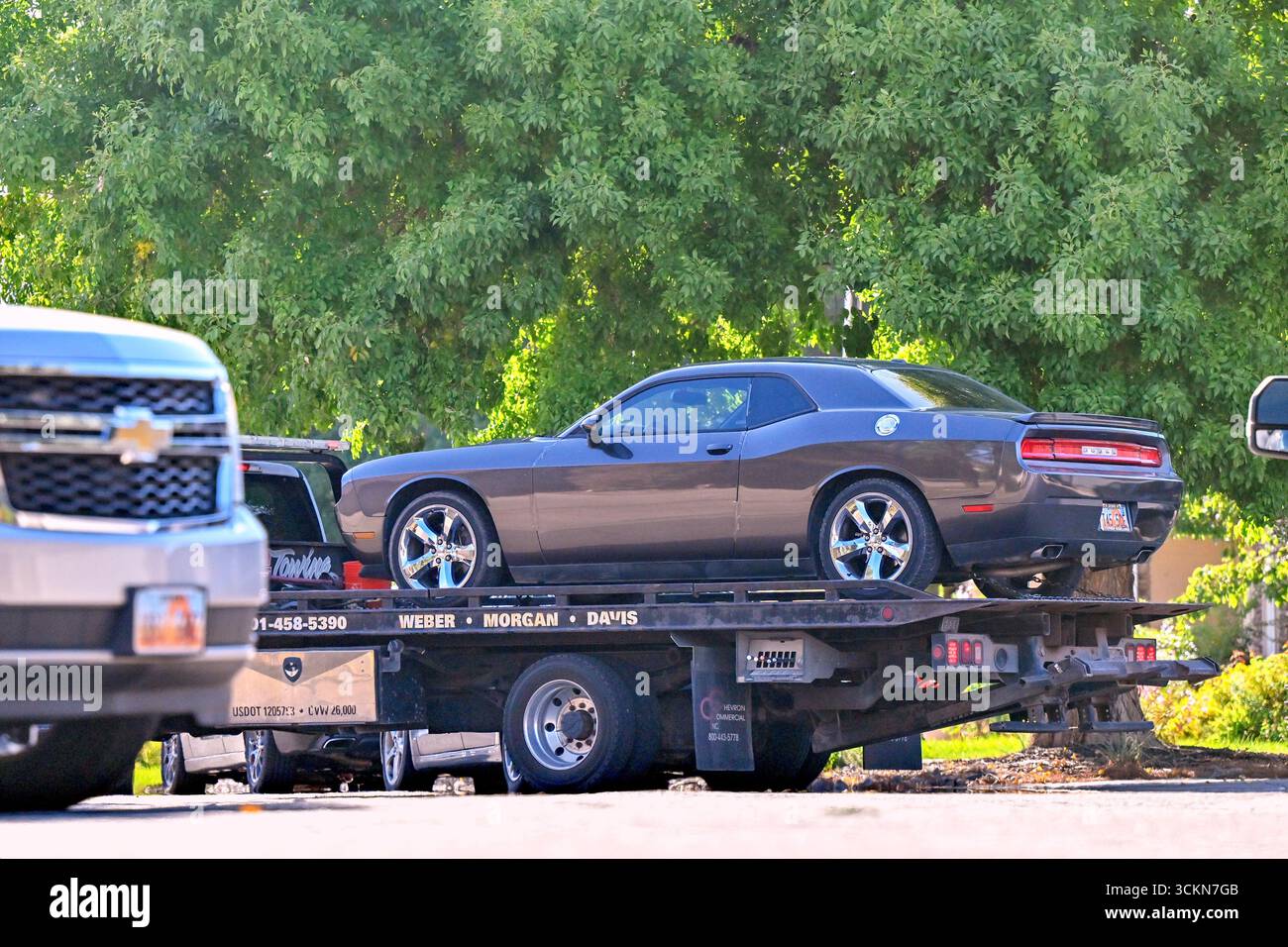 A silver Dodge is towed from the family home of Tyler Robinson, the man ...