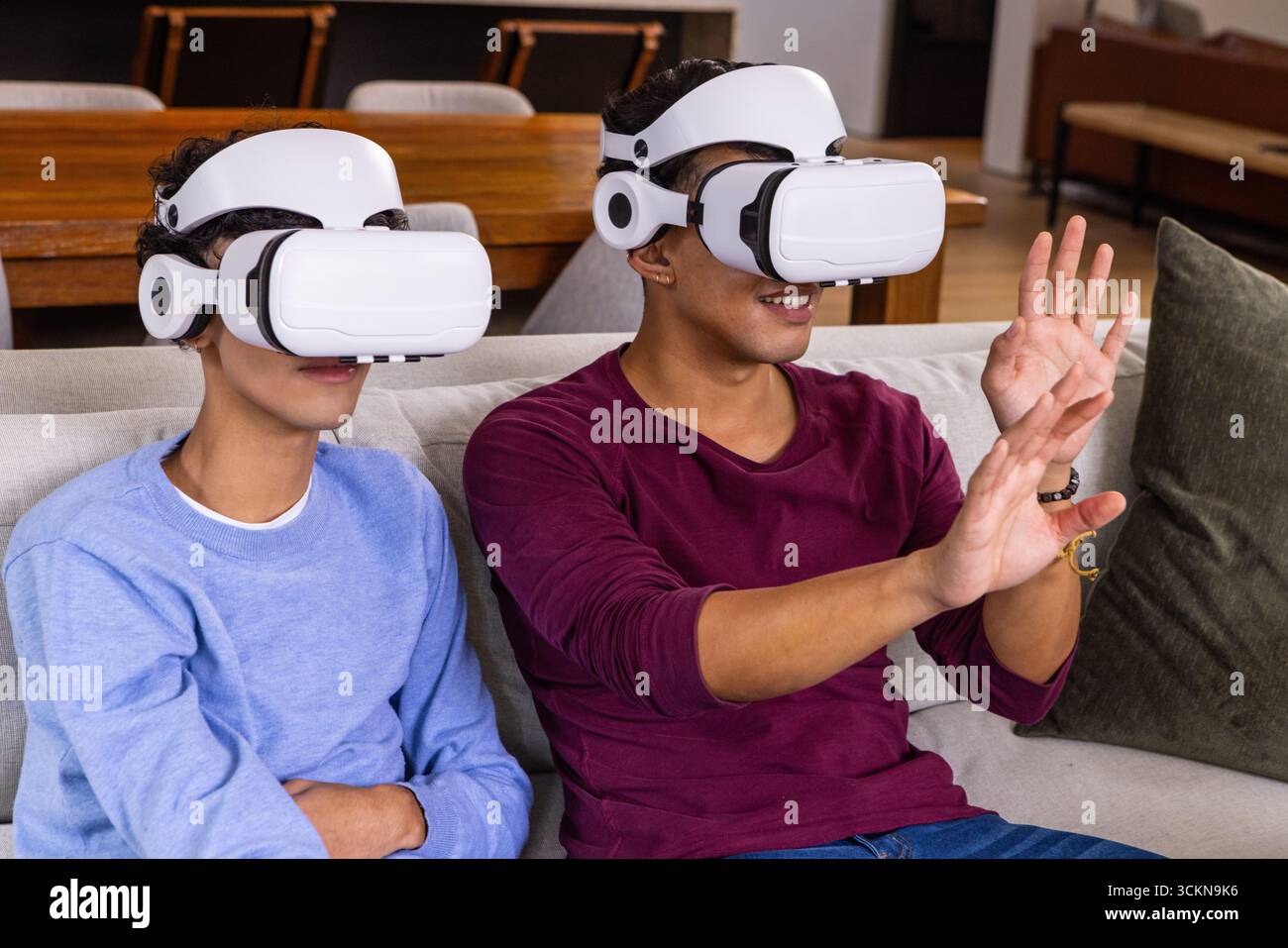 Two friends wearing vr headsets and playing virtual reality games on ...