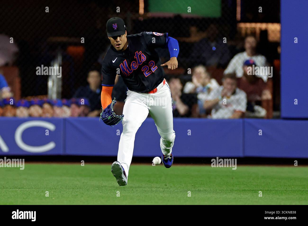 New York Mets outfielder Juan Soto fields a ball throws during the first inning of a baseball ...