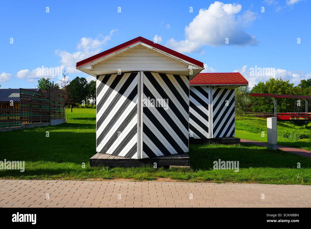 Traditional black and white wooden border guard house marking the open ...