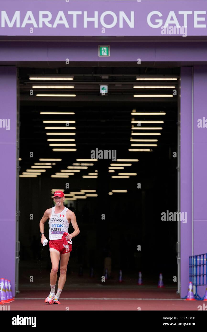 Canada's Evan Dunfee, left, enters the stadium on his way to win the ...
