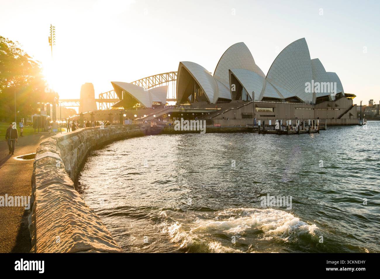 A stunning view of Sydney Opera House and Harbour Bridge at sunset ...