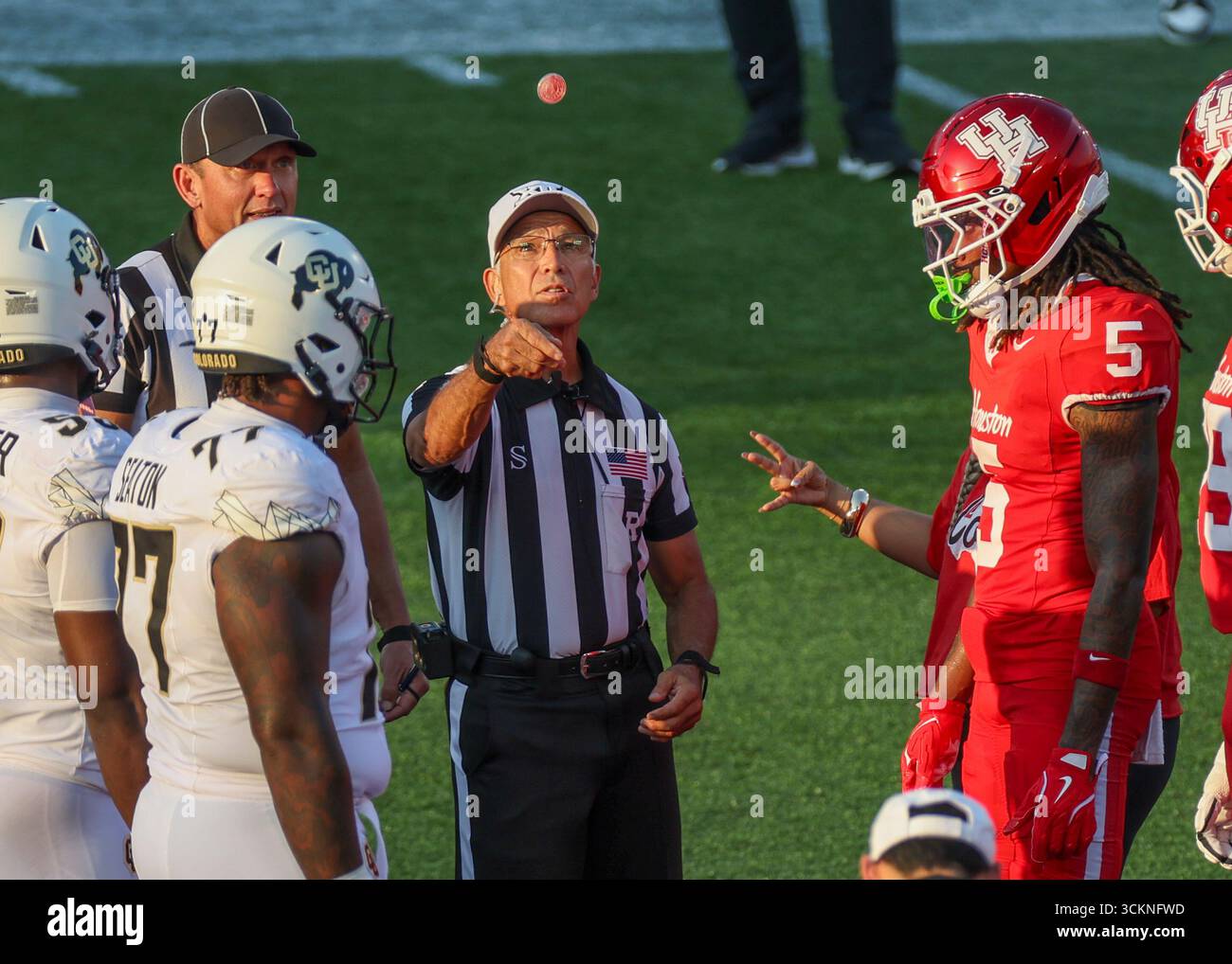 HOUSTON, TX - SEPTEMBER 12: Referee David Alvarez tosses the coin ...