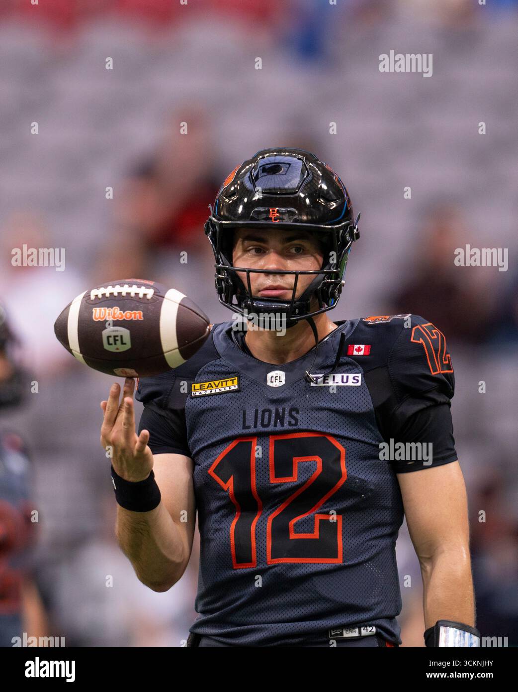 B.C. Lions quarterback Nathan Rourke (12) warms up before a CFL ...