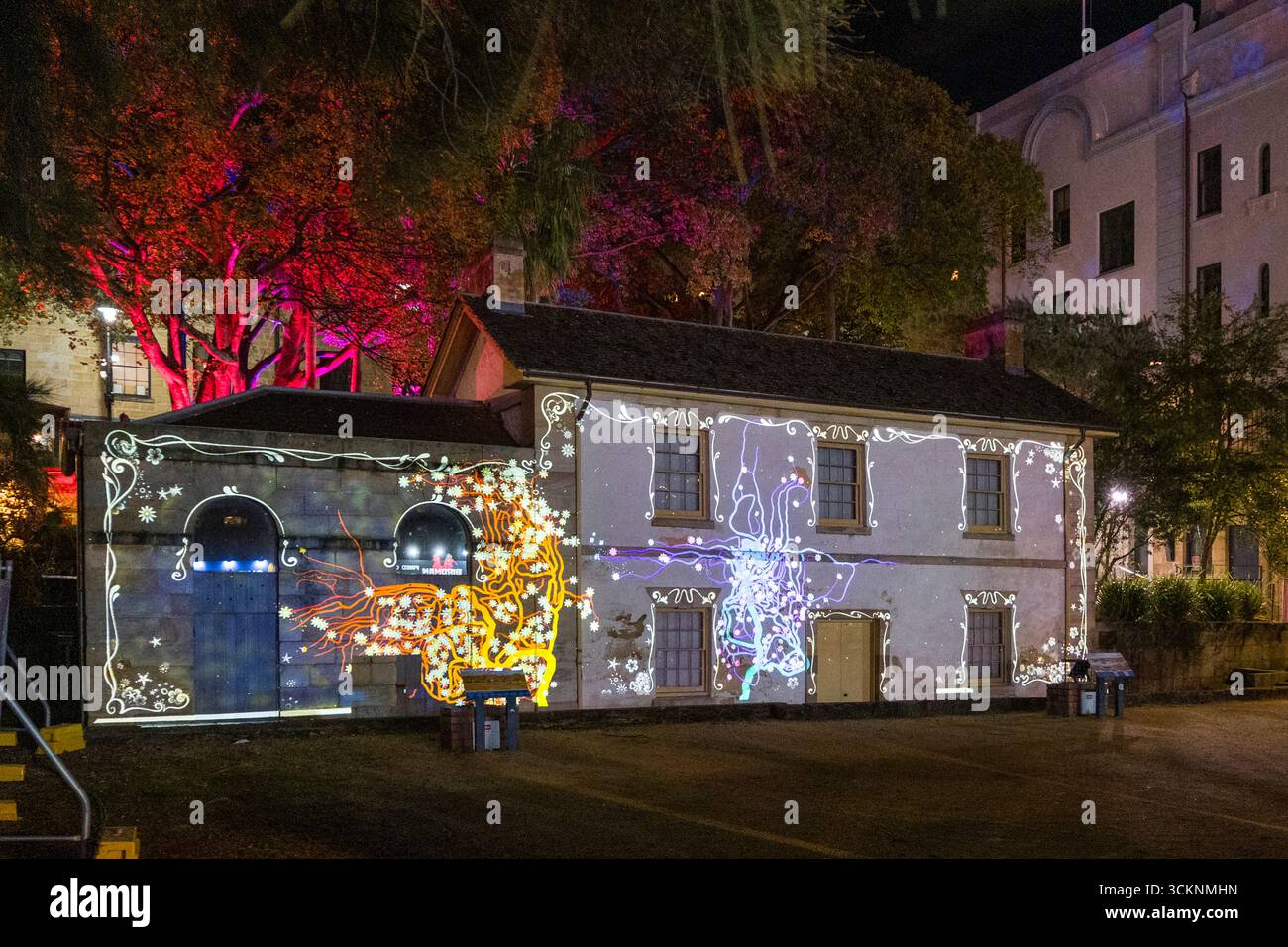 A stunning heritage building illuminated with colorful projections and ...