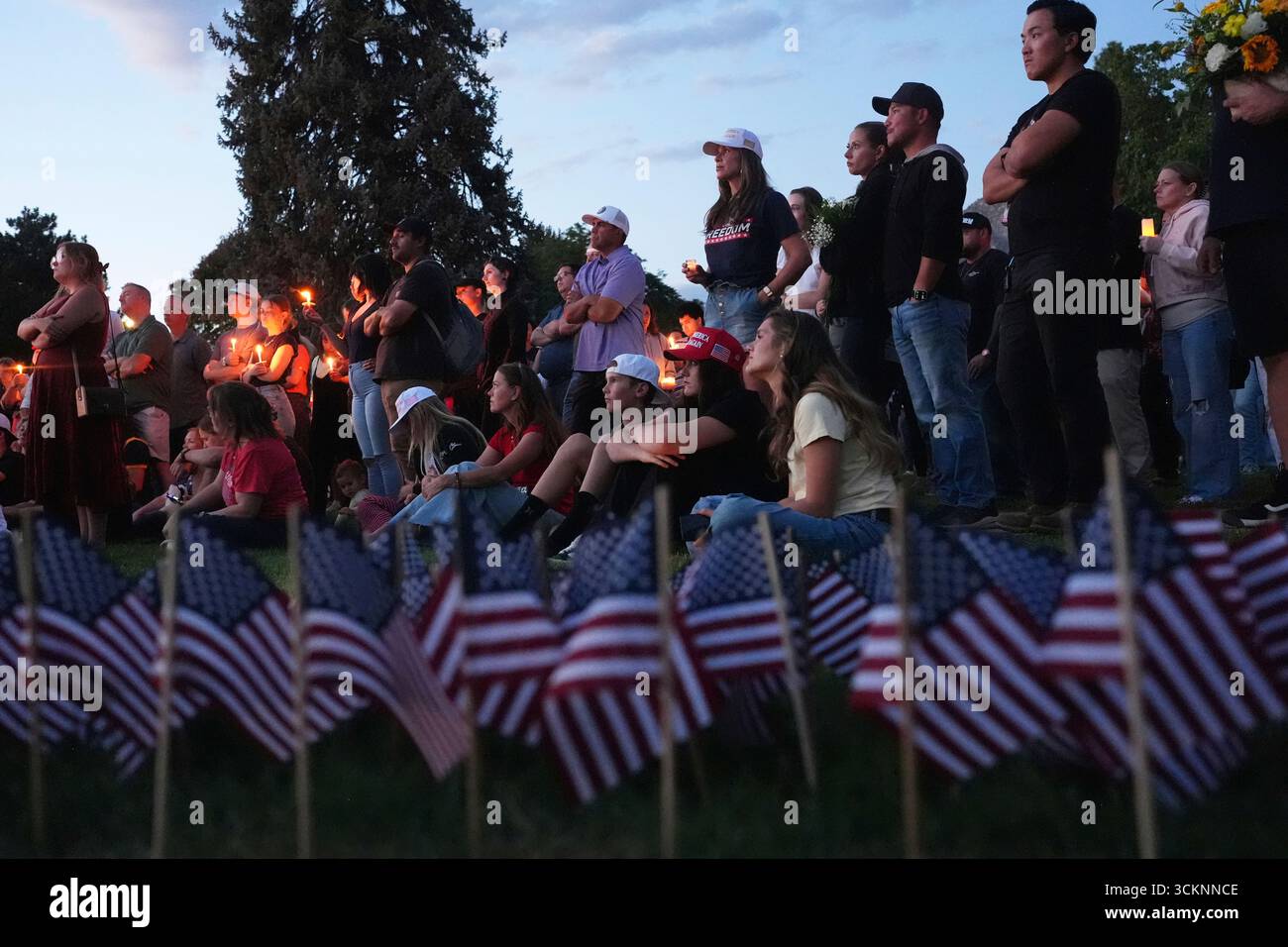 Attendees pay their respects at a vigil for Charlie Kirk on Friday ...