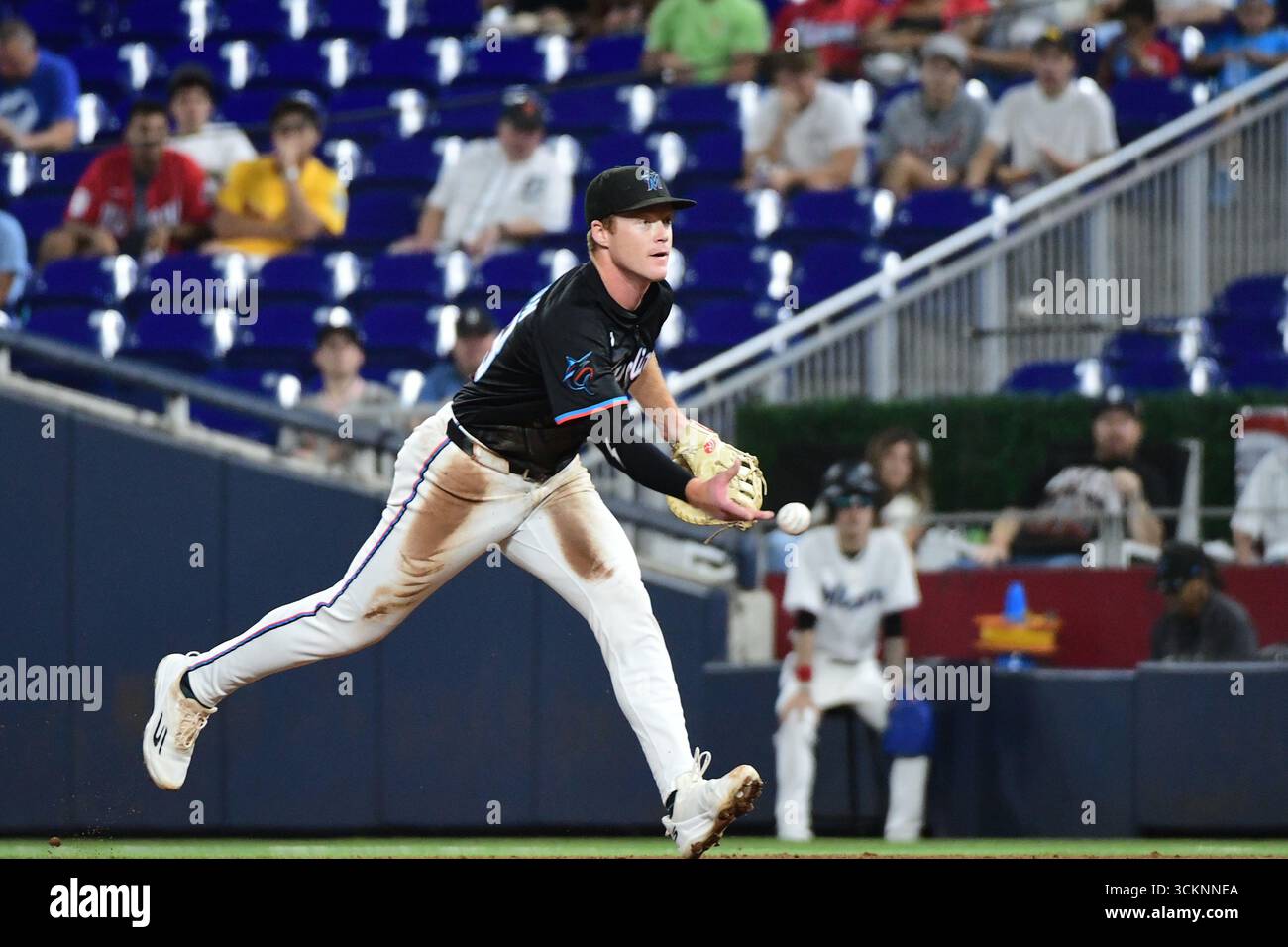 Miami Marlins first baseman Eric Wagaman (33) tosses the ball to first ...