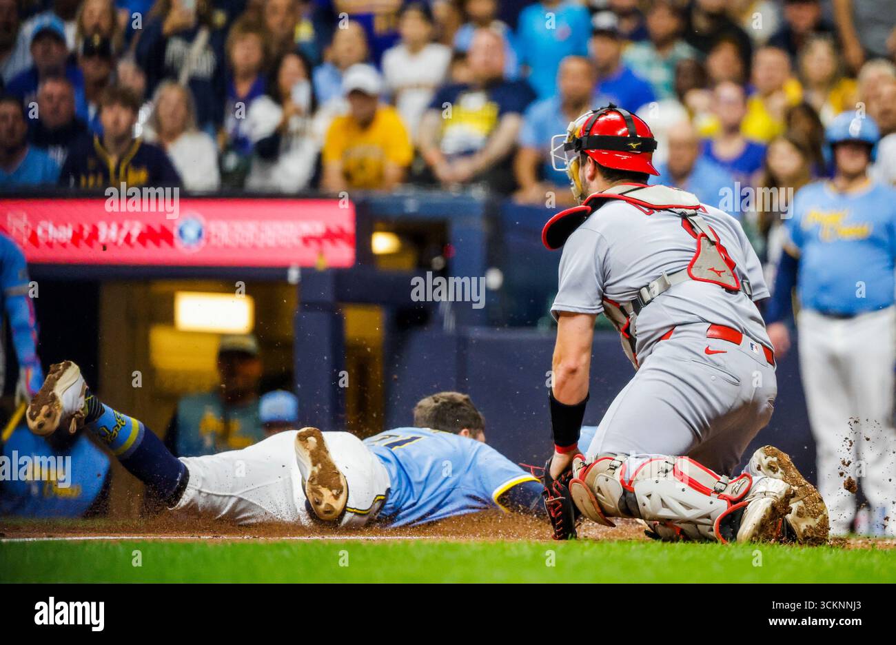 Milwaukee Brewers third baseman Caleb Durbin (L) scores on St. Louis ...