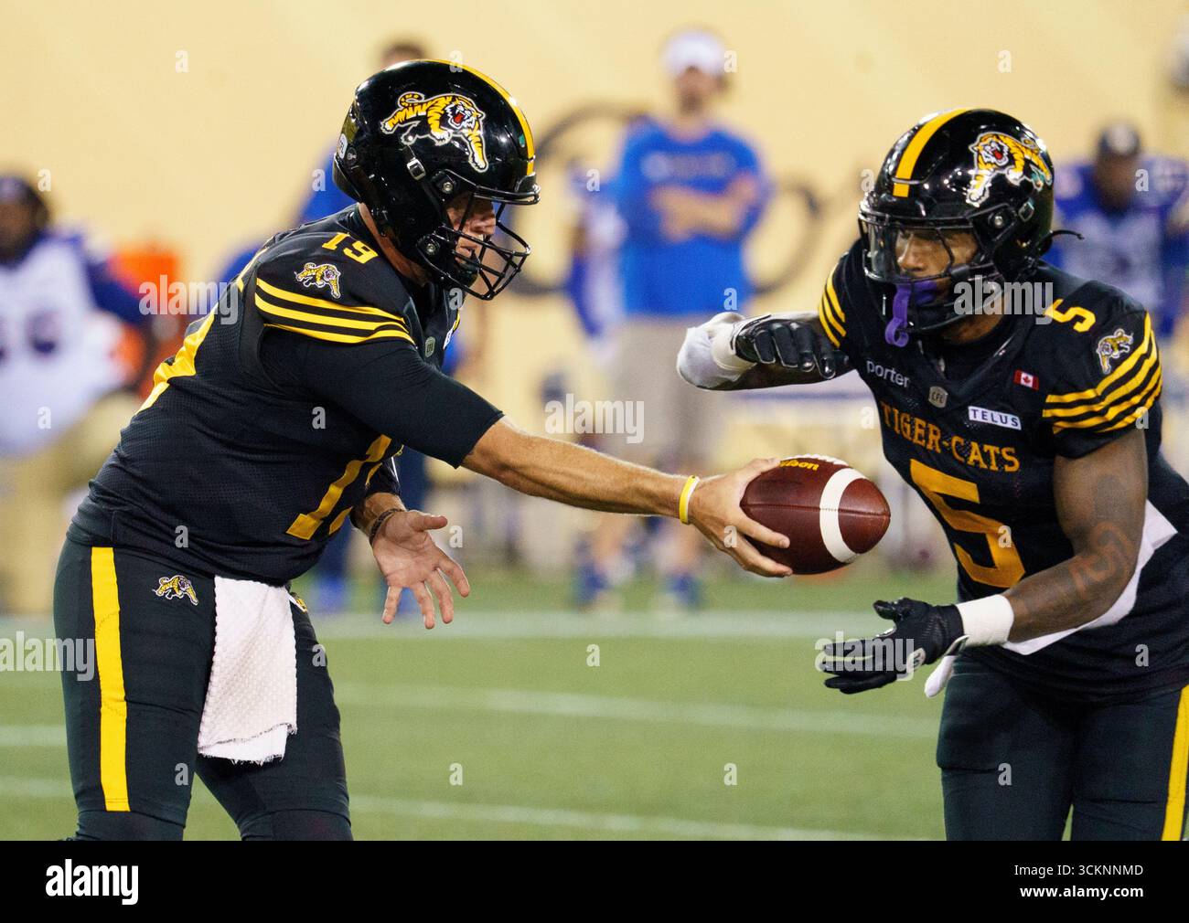 Hamilton Tiger-Cats quarterback Bo Levi Mitchell(19) hands off to ...