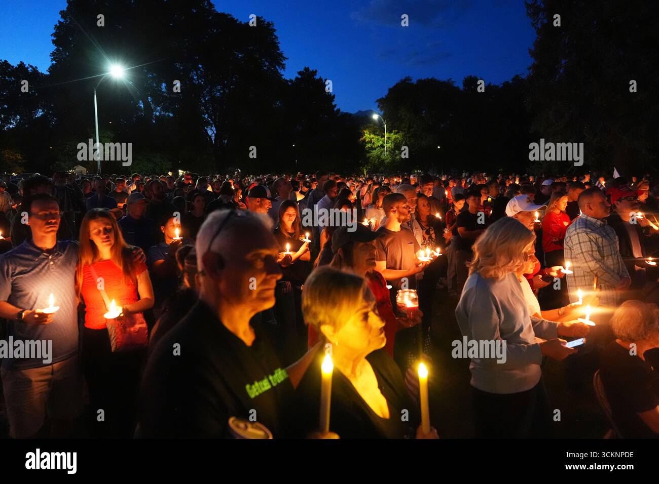 Attendees pay their respects during a vigil for Charlie Kirk on Friday ...