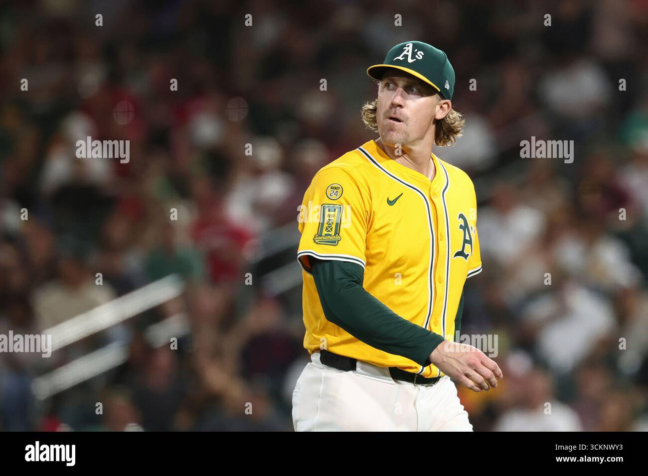 Athletics pitcher Tyler Ferguson looks to the crowd as he walks to the ...