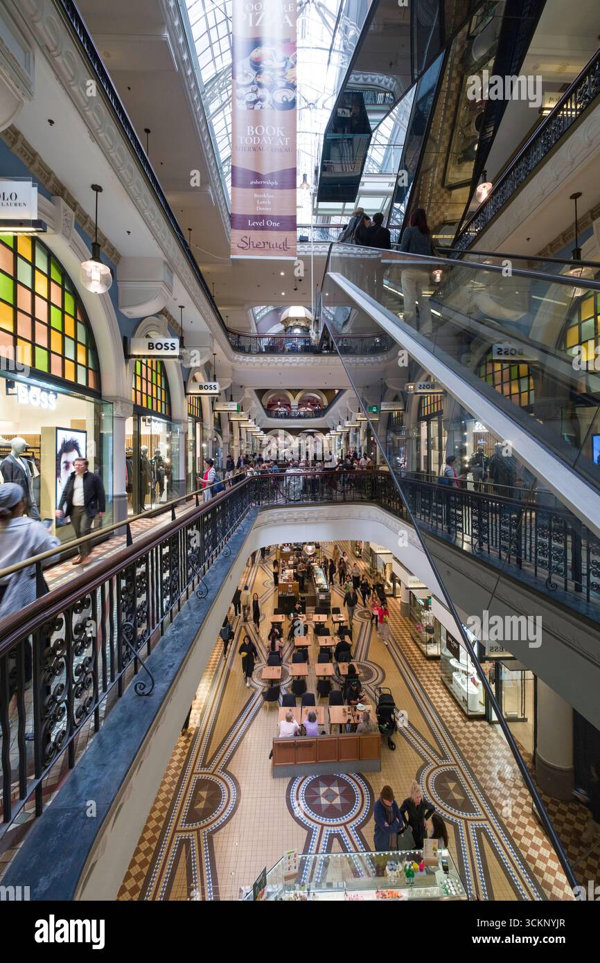 A bustling indoor shopping mall with elegant architectural details and ...