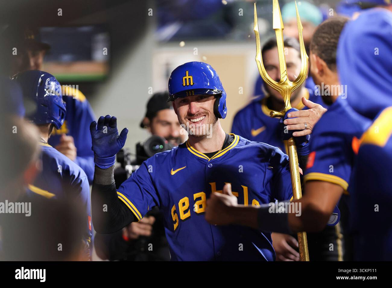 Seattle Mariners' Mitch Garver celebrates in the dugout after hitting a ...