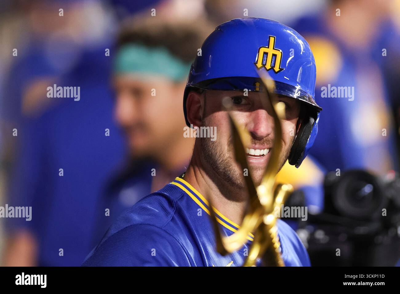 Seattle Mariners' Mitch Garver celebrates in the dugout after hitting a ...
