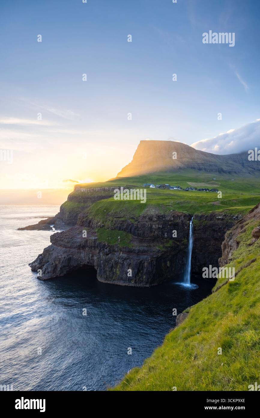 View of the Mulafossur waterfall with the small village of Gasadalur ...