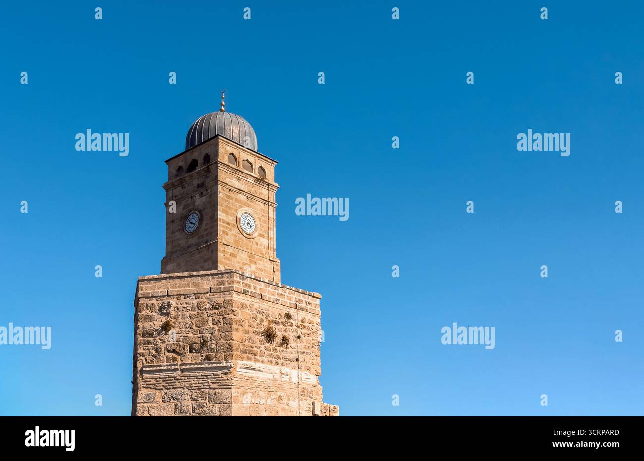 The historic clock tower in front of the deep blue sky in Antalya Stock ...