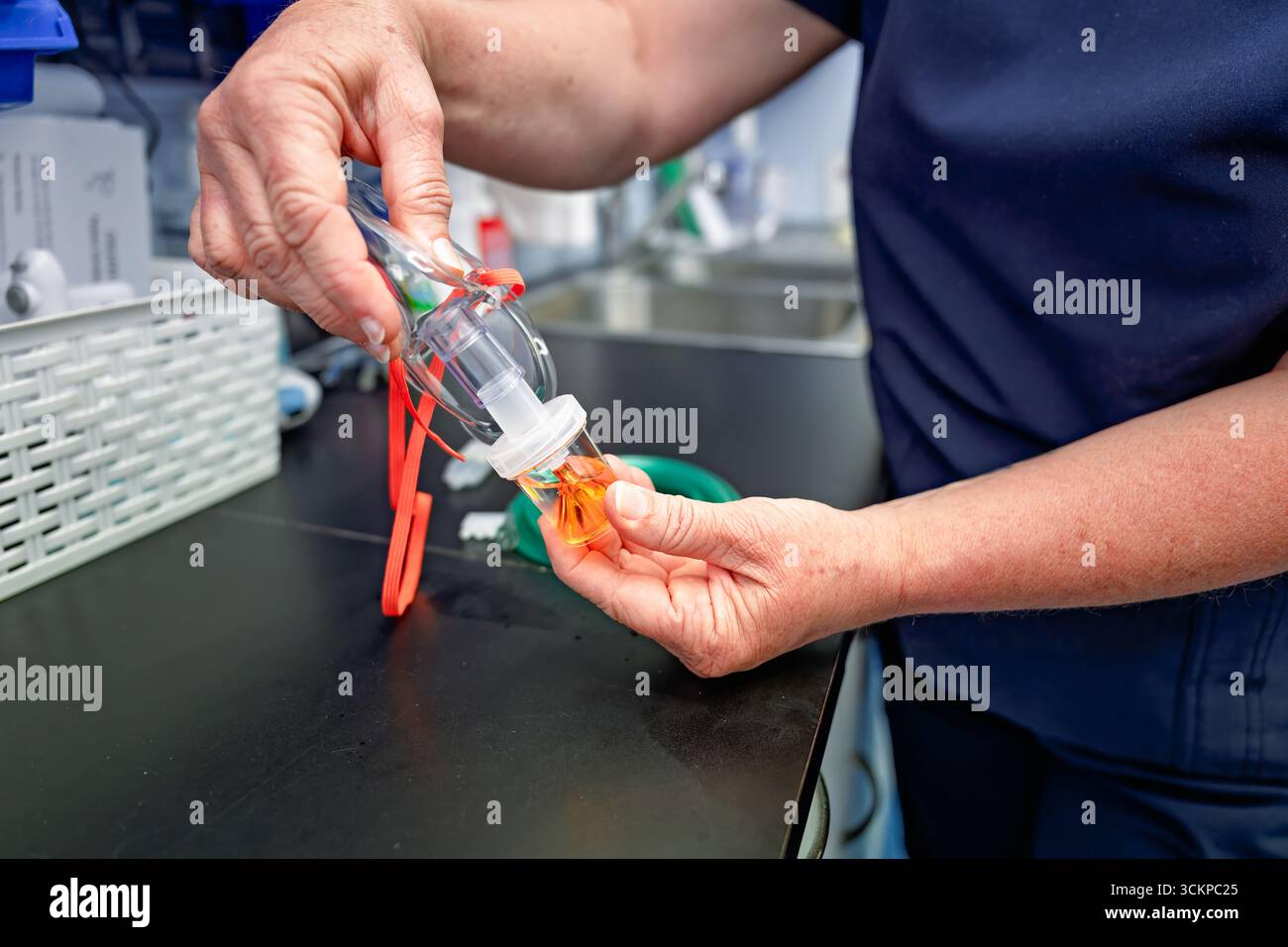 nurse setting up nebuliser medication and oxygen mask from cylinder for ...