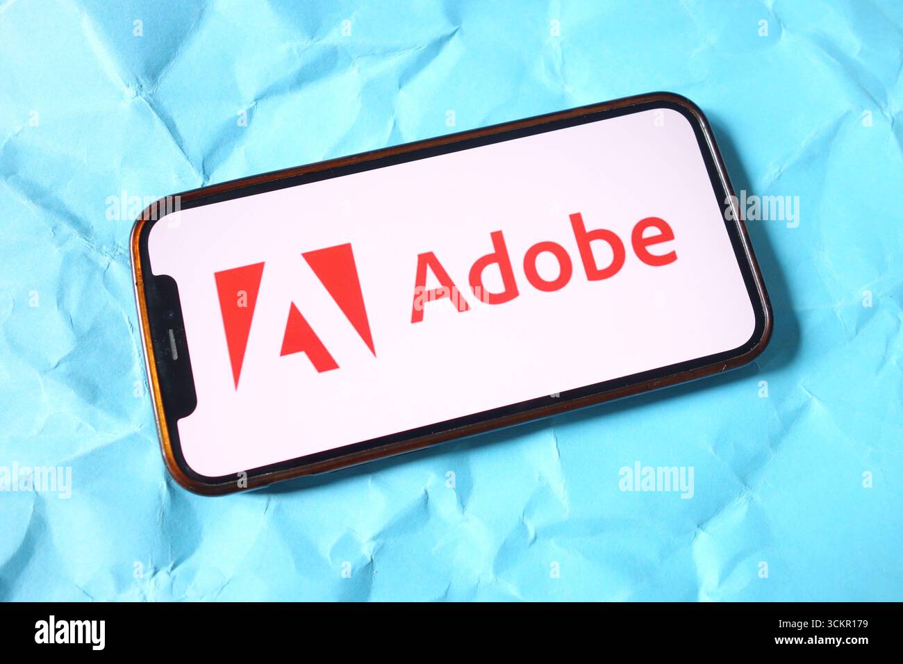 In this photo illustration, the Adobe company logo is seen displayed on ...