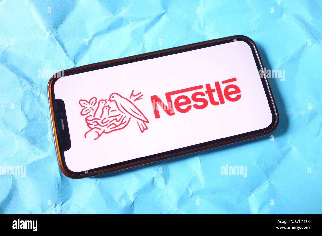 In this photo illustration, the Nestle company logo is seen displayed on a smartphone screen ...