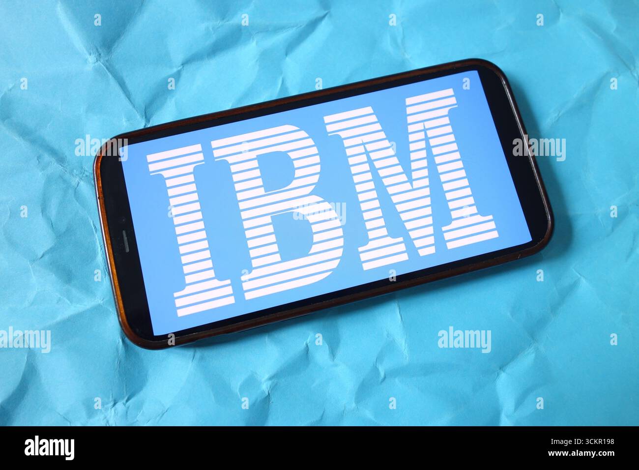 In this photo illustration, the IBM company logo is seen displayed on a ...