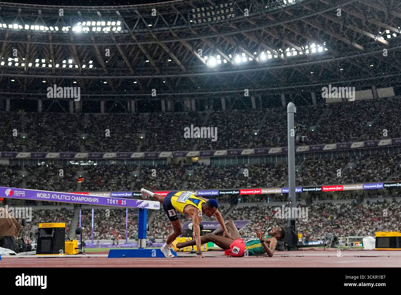 Colombia's Carlos San Martin, left, and Ethiopia's Lamecha Girma fall ...