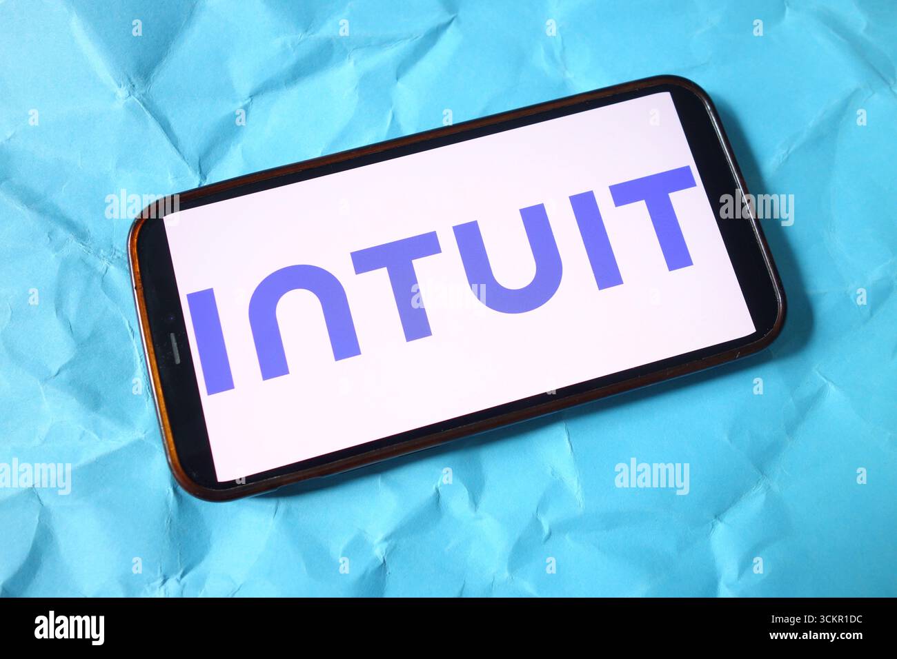 In this photo illustration, the Intuit company logo is seen displayed ...