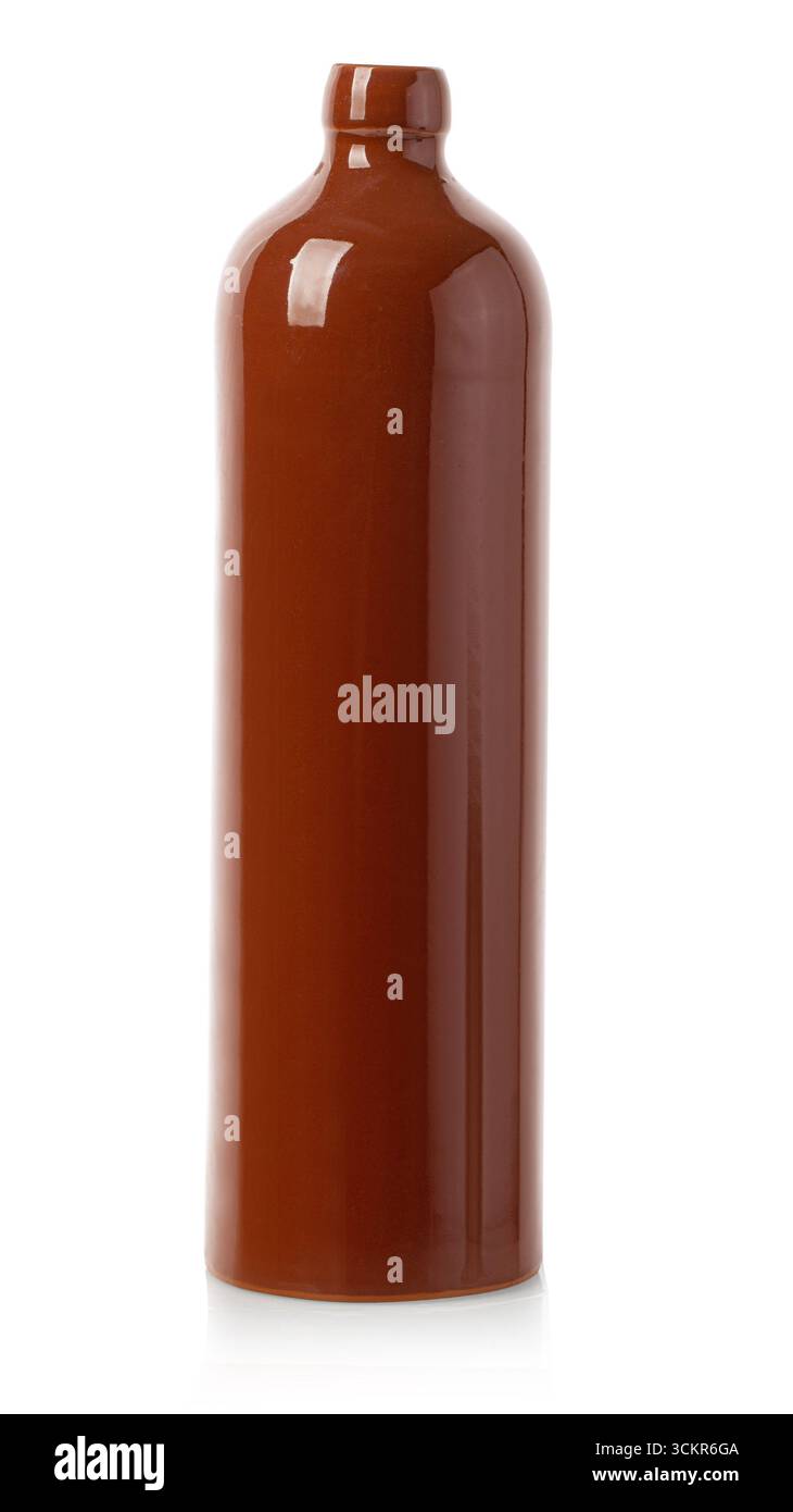 Shiny brown ceramic bottle standing on a reflective white background ...