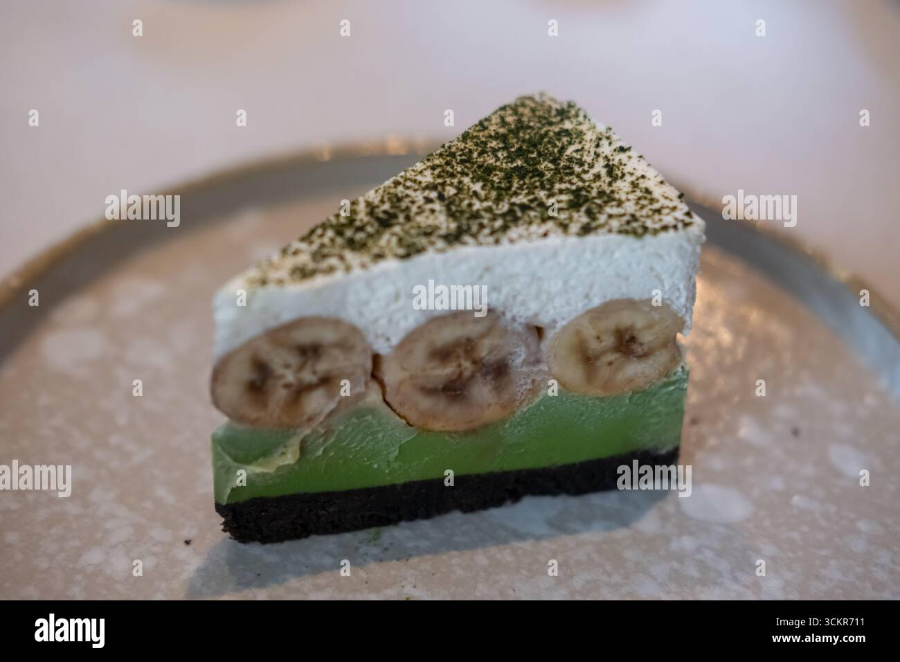 Matcha green tea banoffee pie, served on plate. It is a dessert made ...