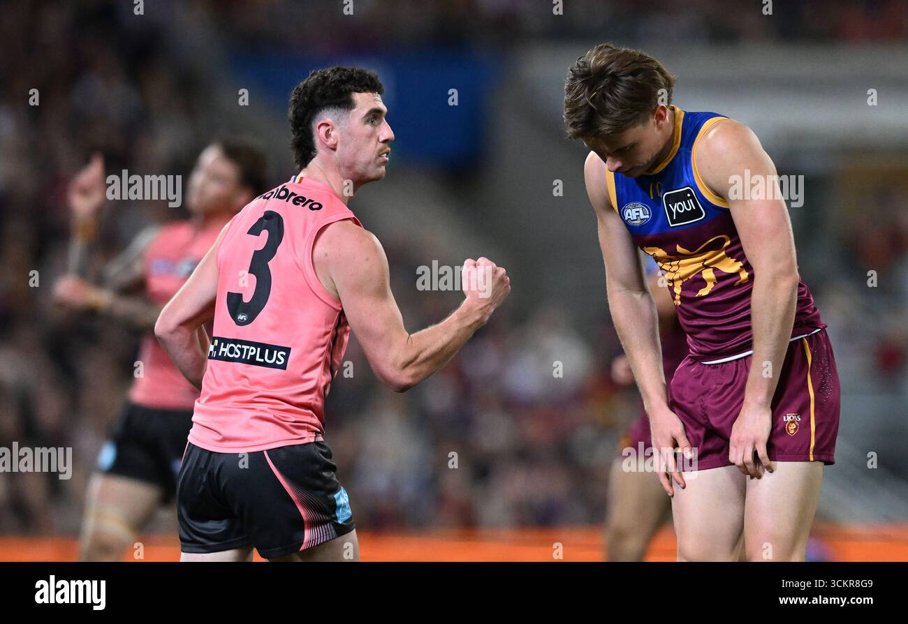 Sam Flanders (left) of the Suns celebrates kicking a goal during the ...