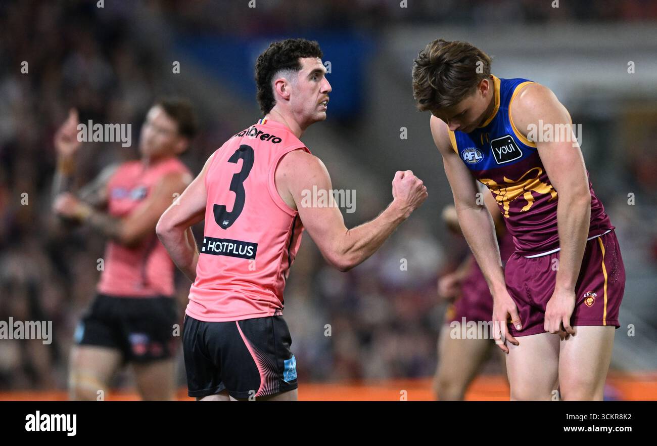 Sam Flanders (left) of the Suns celebrates kicking a goal during the ...