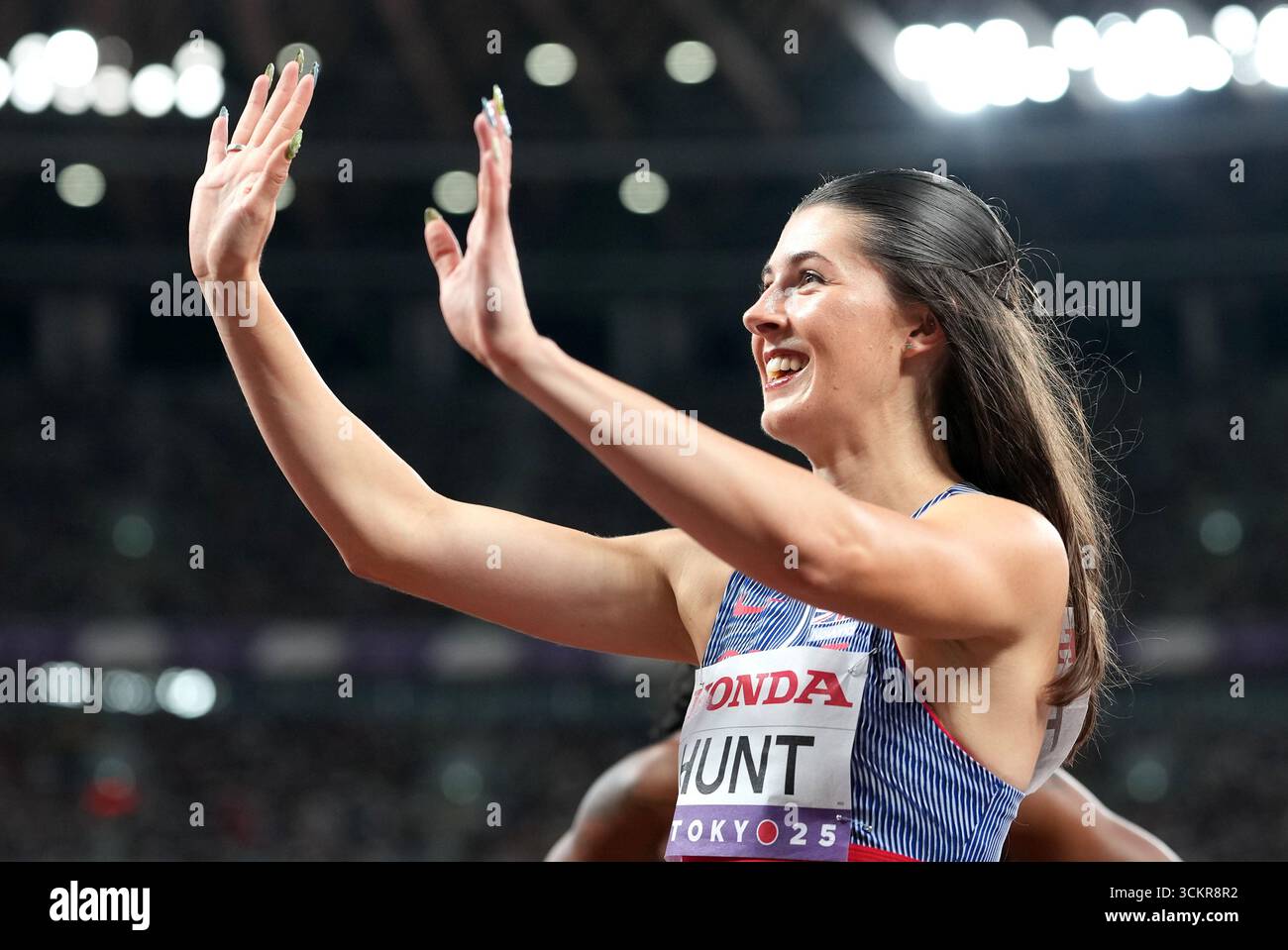 Amy Hunt of Great Britain (centre) after finishing second in heat 6 of ...
