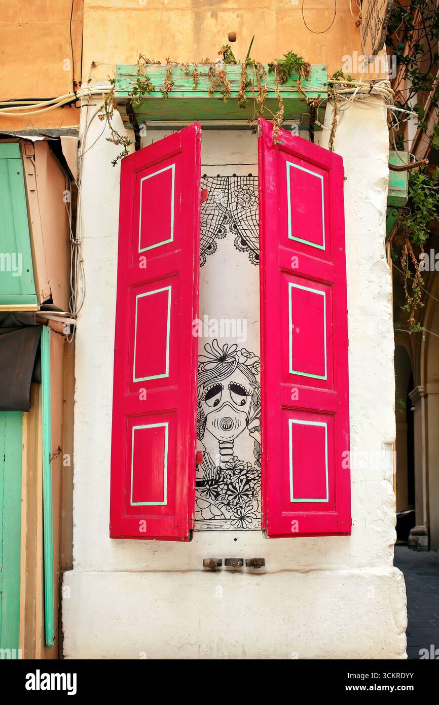 Imitation window with red shutters on the corner of an old house ...