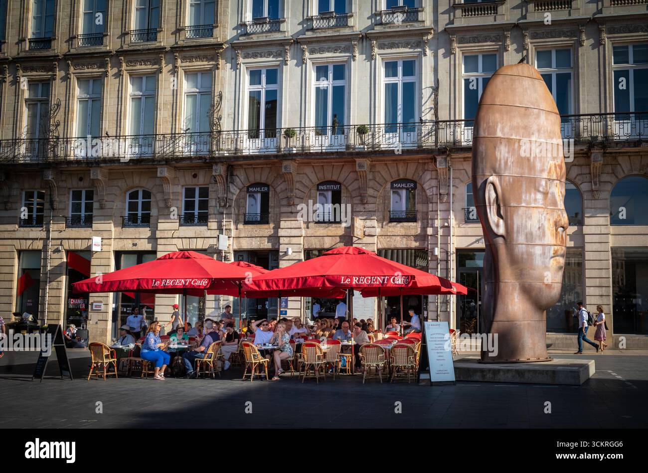 A street cafe and the 7m tall cast iron sculpture of a face called ...