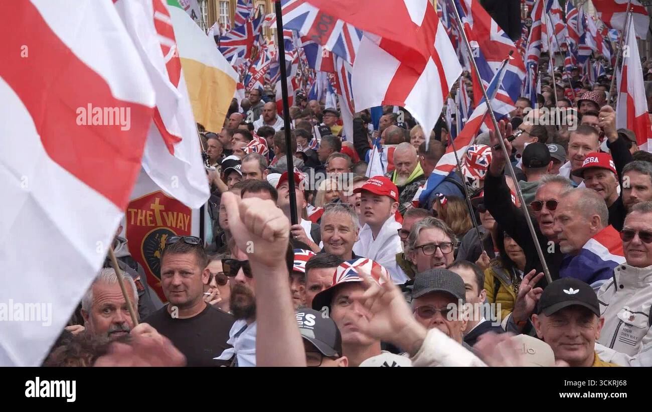 People fly Union Flags and the St George Cross during a Tommy Robinson ...