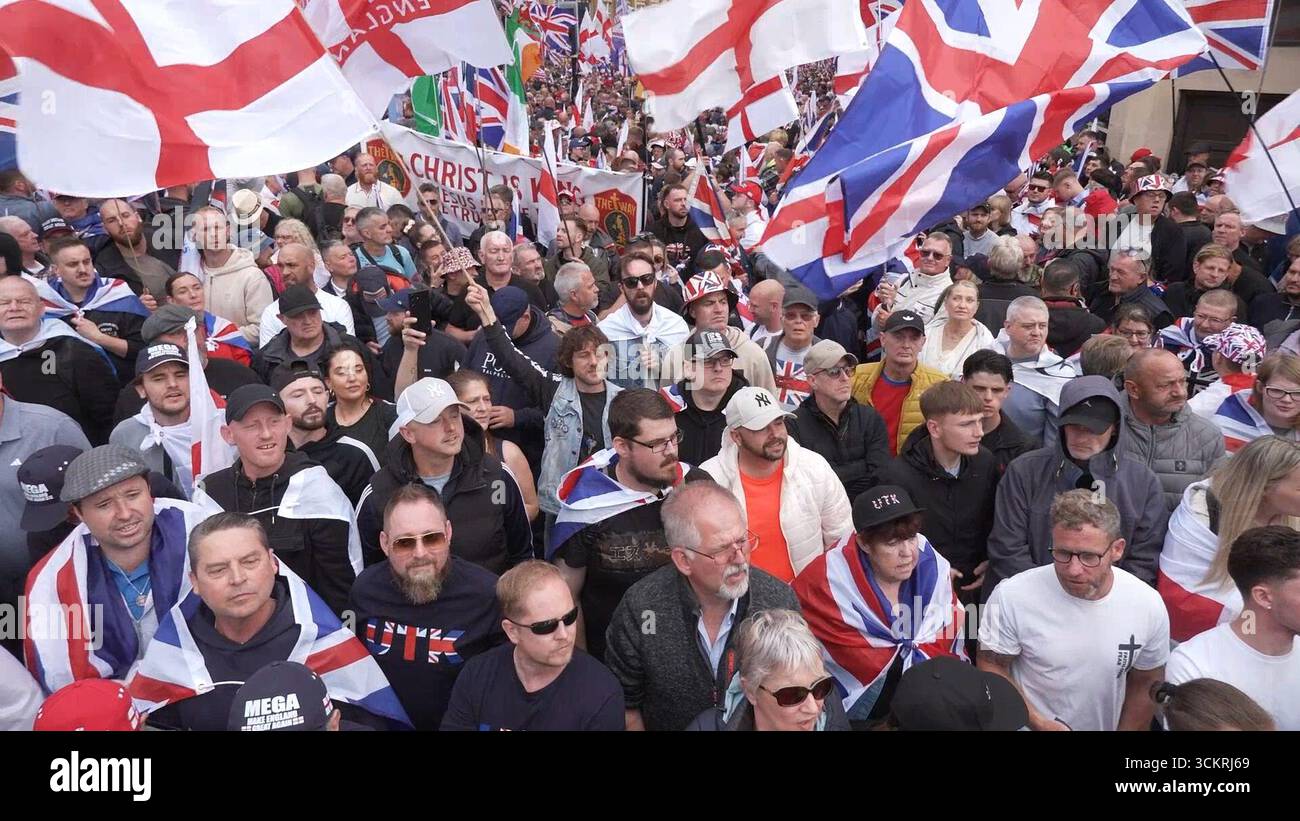 People fly Union Flags and the St George Cross during a Tommy Robinson ...