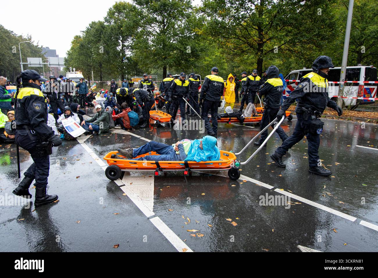 Police officers intervene in a blockade by climate activists from the ...