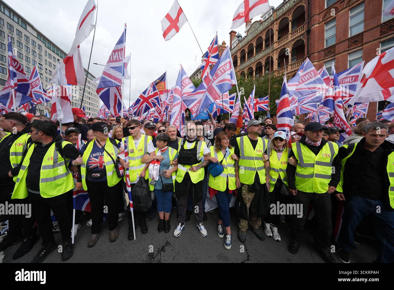 Activists fly Union flags and the St George Cross during the Tommy ...