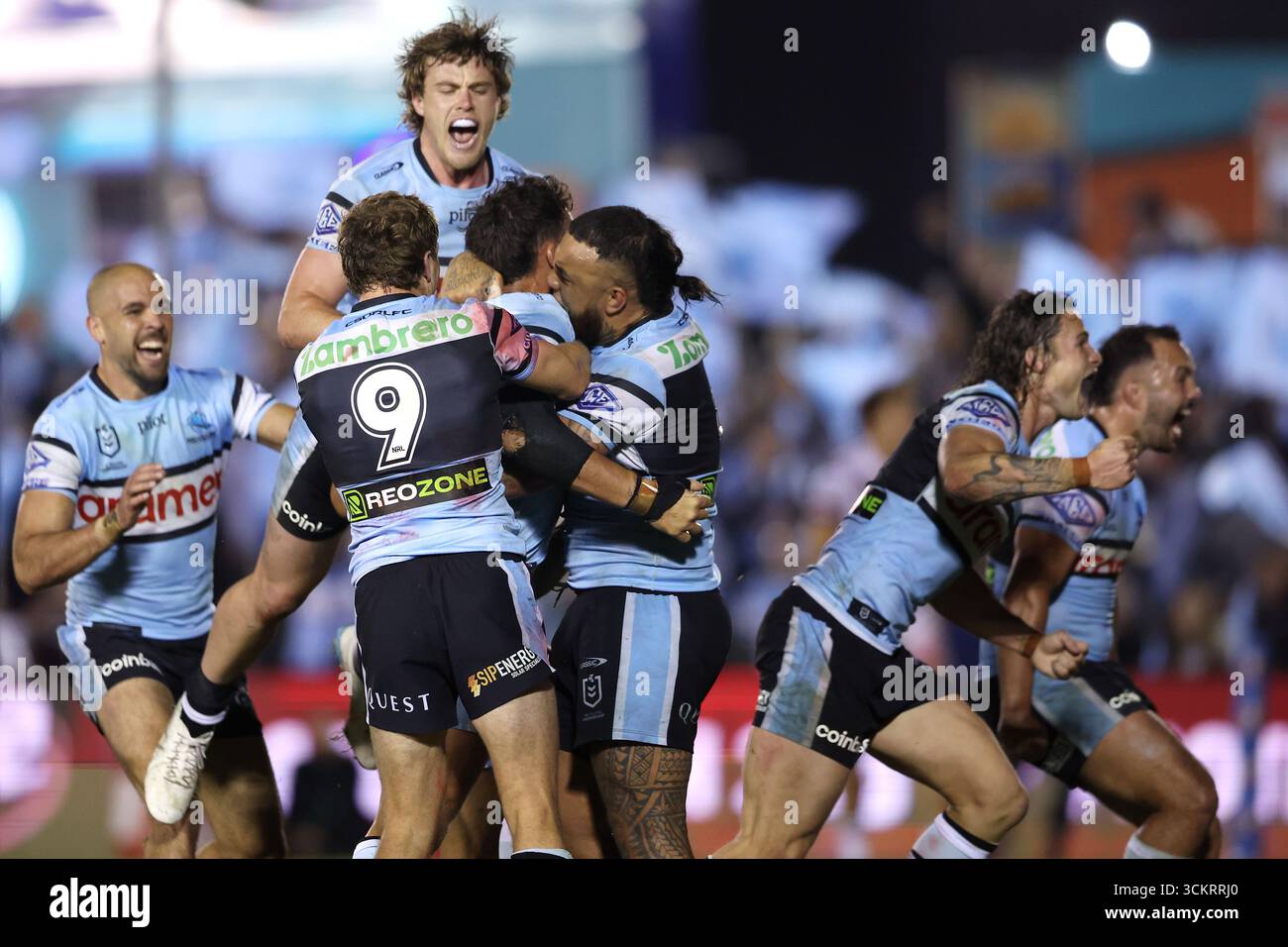 Toby Rudolf of the Sharks celebrates with his team mates after scoring ...