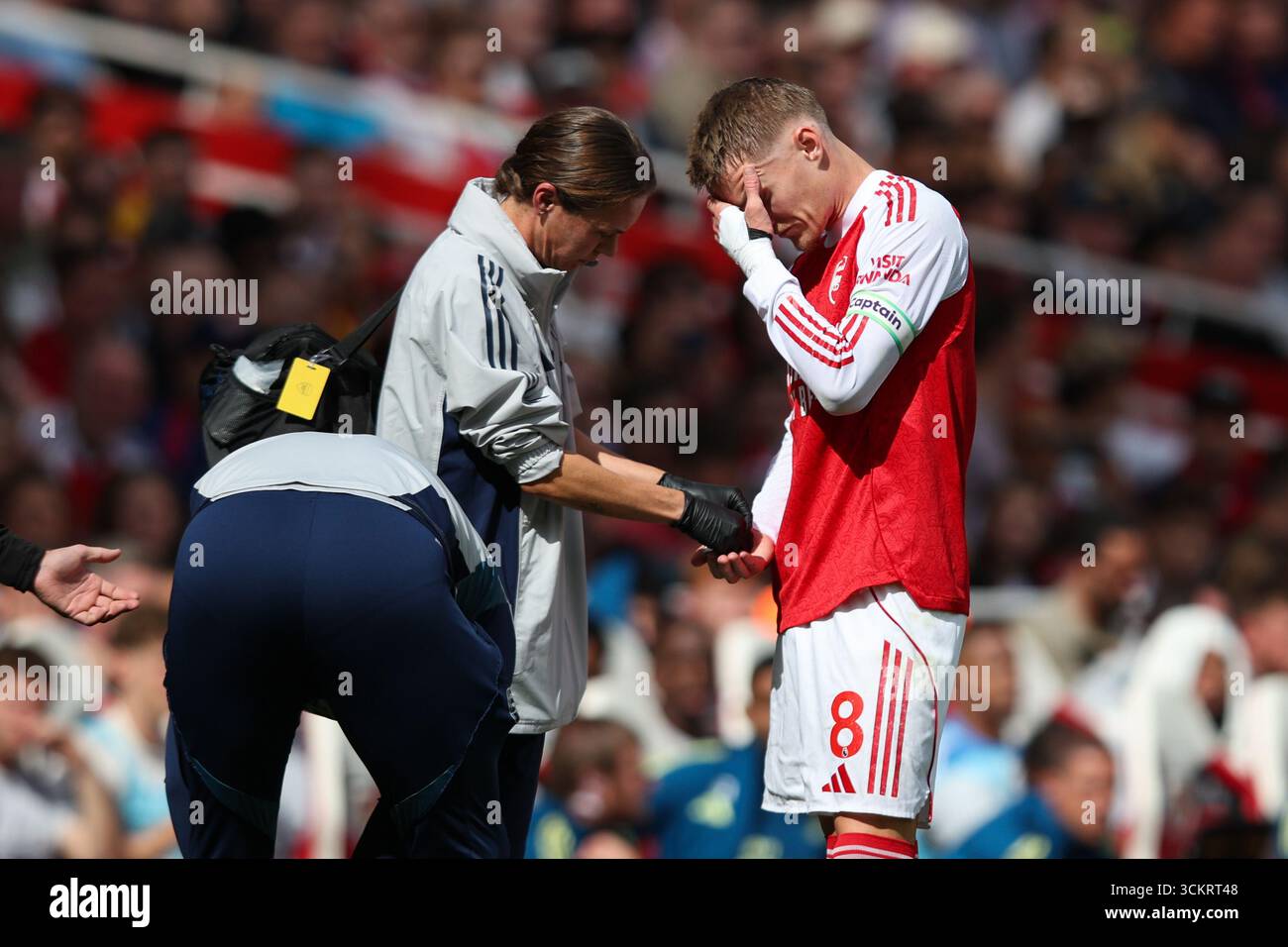 LONDON, UK - 13th Sept 2025: Martin Odegaard of Arsenal in pain with a shoulder injury and ...