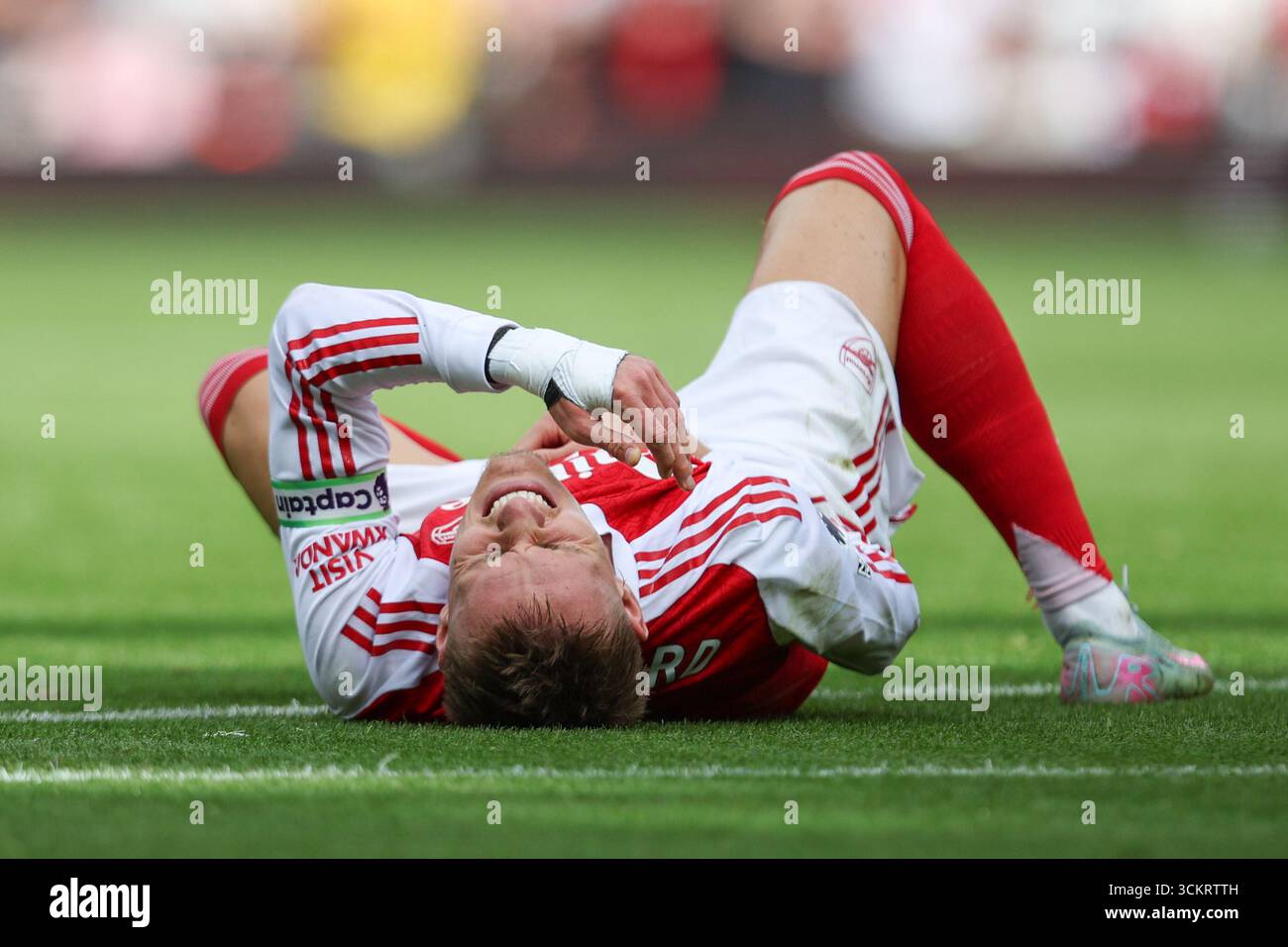 LONDON, UK - 13th Sept 2025: Martin Odegaard of Arsenal in pain with a shoulder injury and ...
