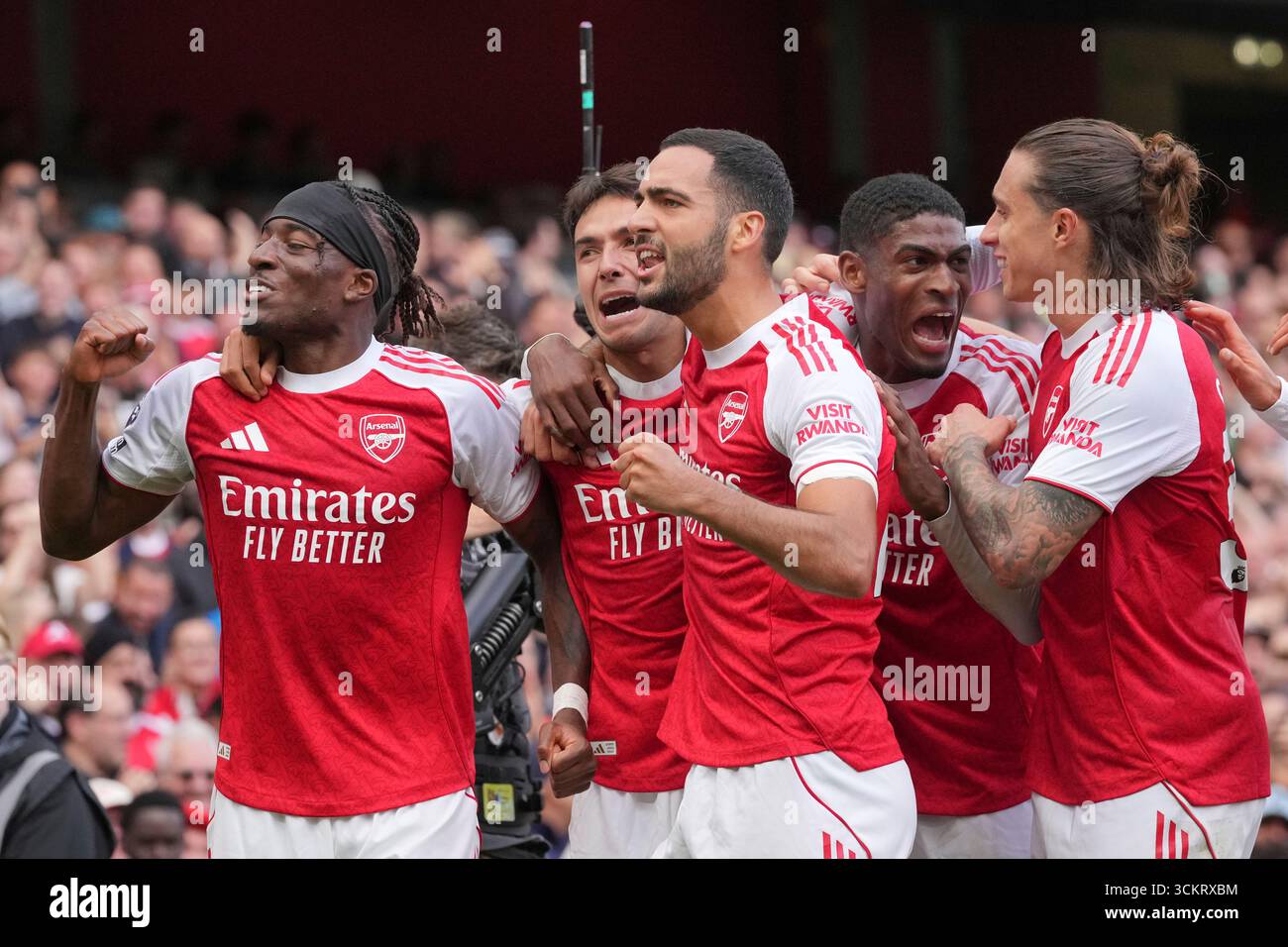 Arsenal players celebrate after a goal during the Premier League soccer ...
