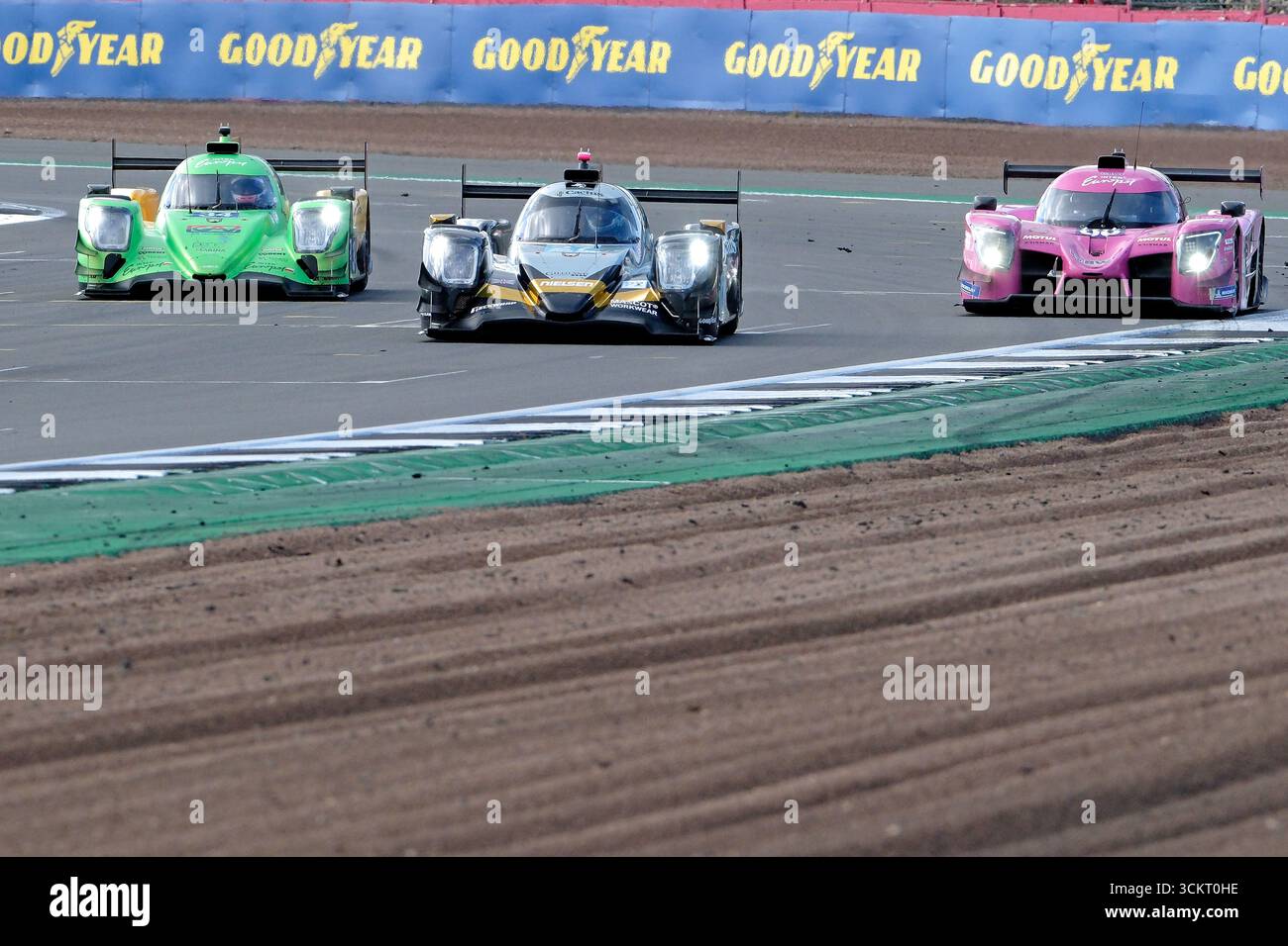 Three cars abreast as they corner onto the Hamilton Straight On track ...