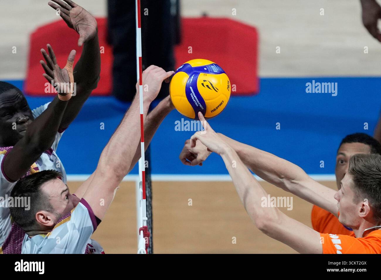 Jasper Wijkstra, right, of the Netherlands tries to block the shot of Borislav Georgiev of Qatar ...