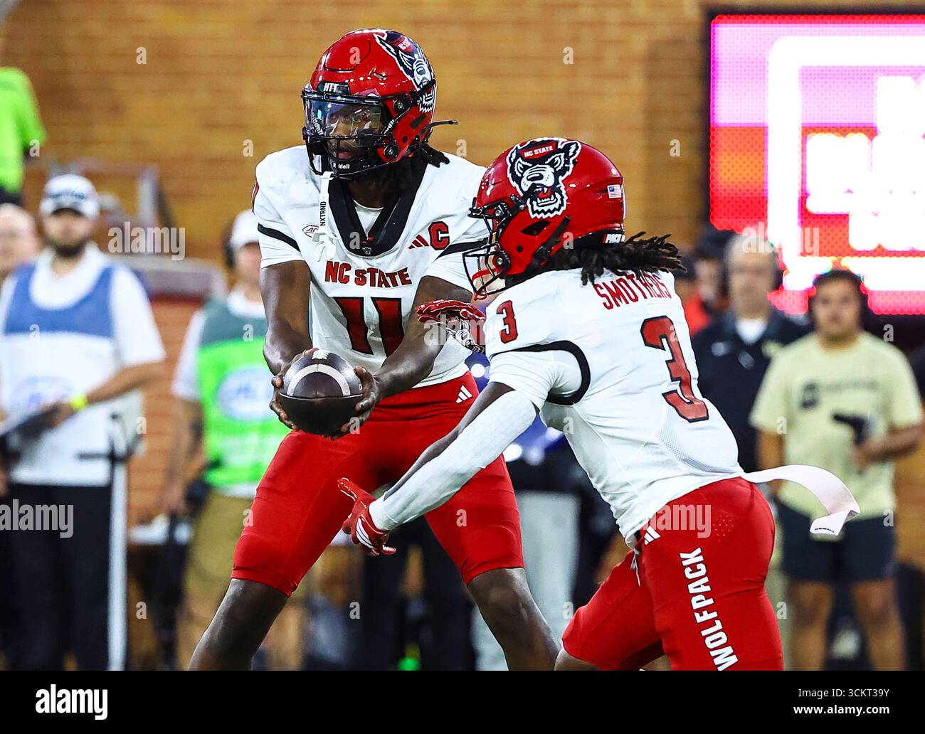 September 11,2025: NC State quarterback CJ Bailey (11) hands ball to NC ...